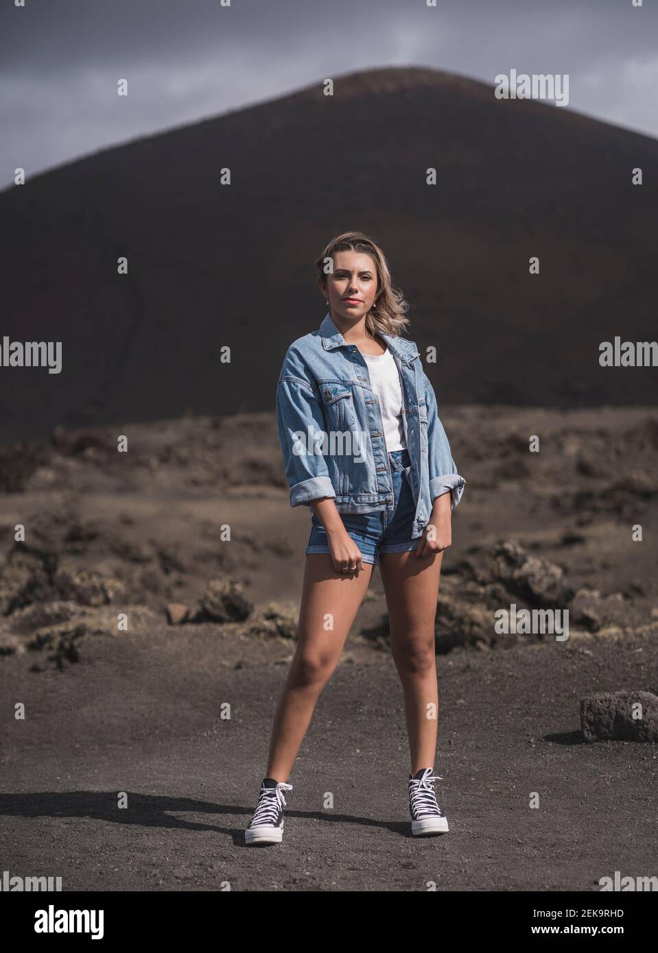 Woman staring while standing against mountain at Volcano El Cuervo ...