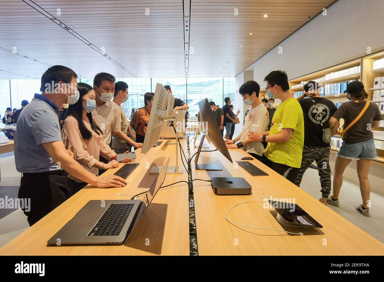 People experience Apple products at the newly-opened Apple Store at ...