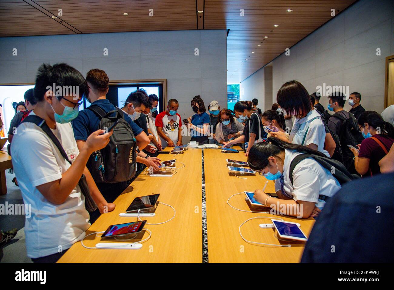 People experience Apple products at the newly-opened Apple Store at ...