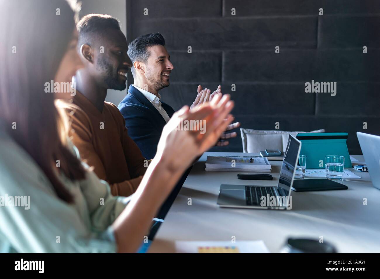Sitting smiling looking away clapping hands hi-res stock photography ...