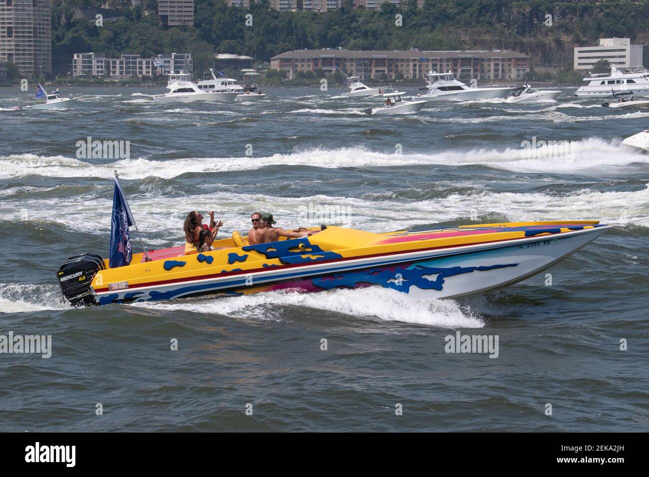 One of the huge flotilla of boats displaying Trump 2020 flags as they ...