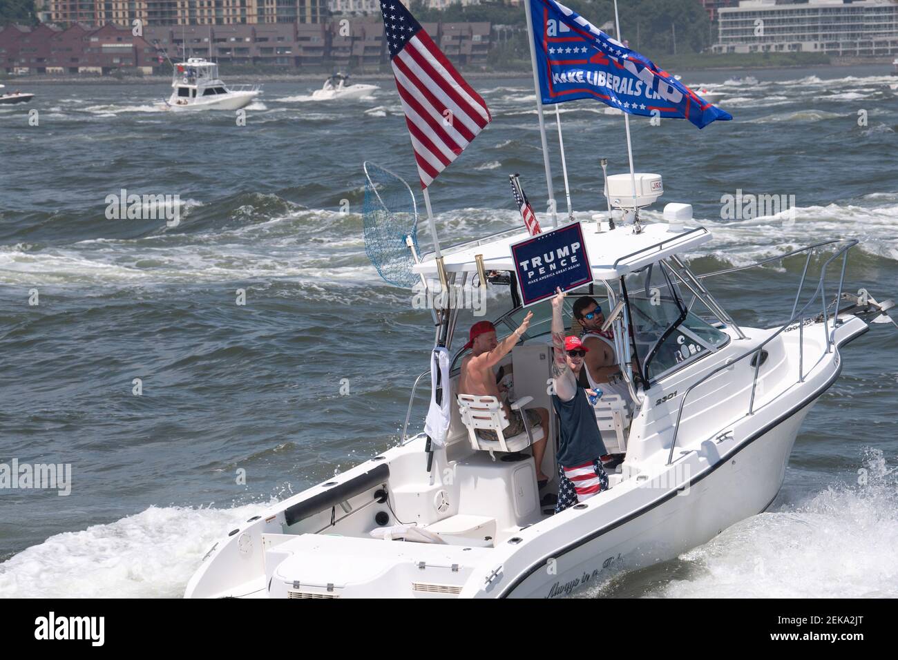 One of the huge flotilla of boats displaying Trump 2020 flags as they ...
