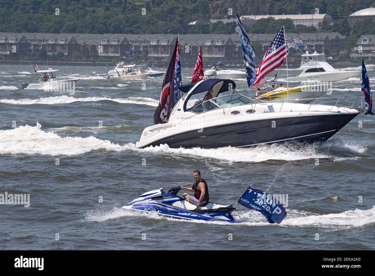 A huge flotilla of boats and jetski displaying Trump 2020 flags as they ...