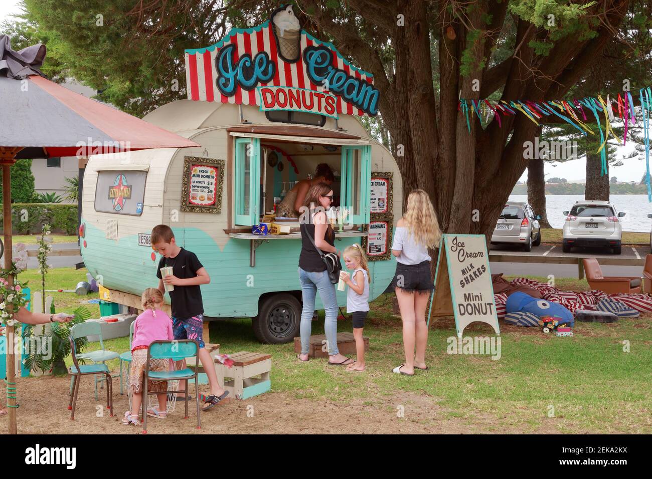 An ice cream and donut stall operating out of a tiny vintage caravan at ...