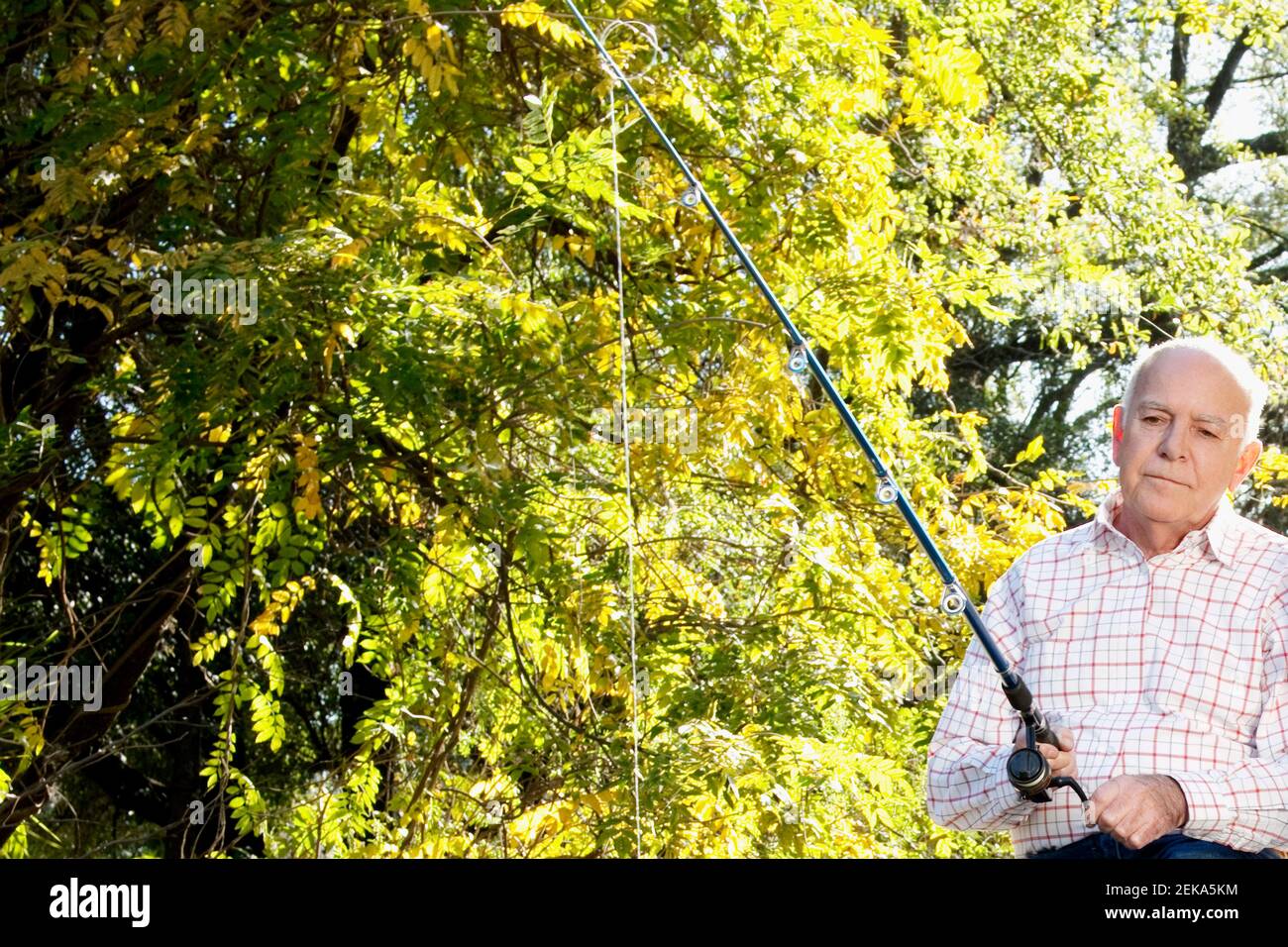 Man holding a fishing rod Stock Photo - Alamy