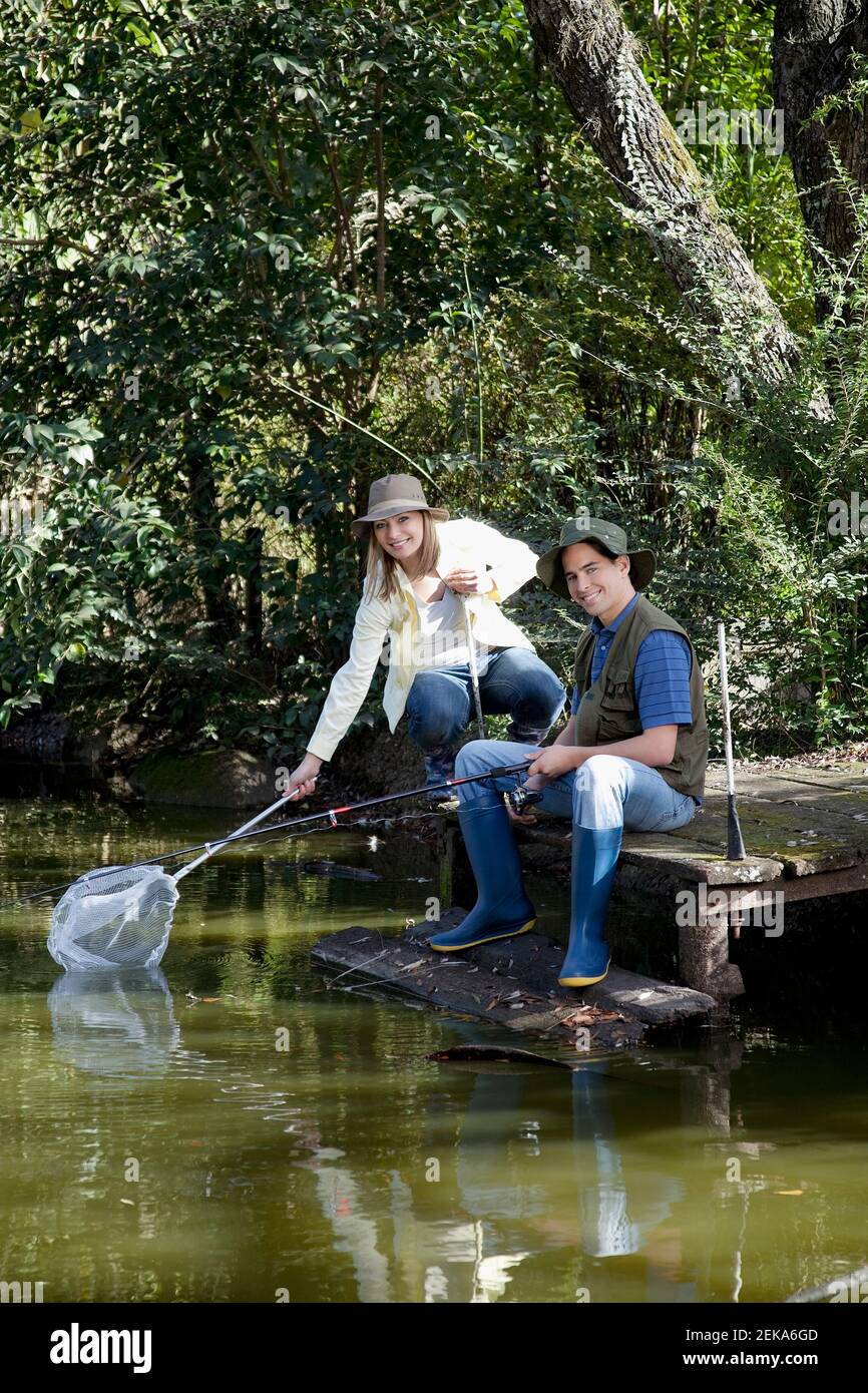 Couple fly fishing in a river Stock Photo - Alamy