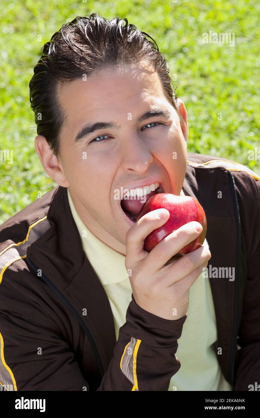 Portrait of a man eating an apple Stock Photo - Alamy