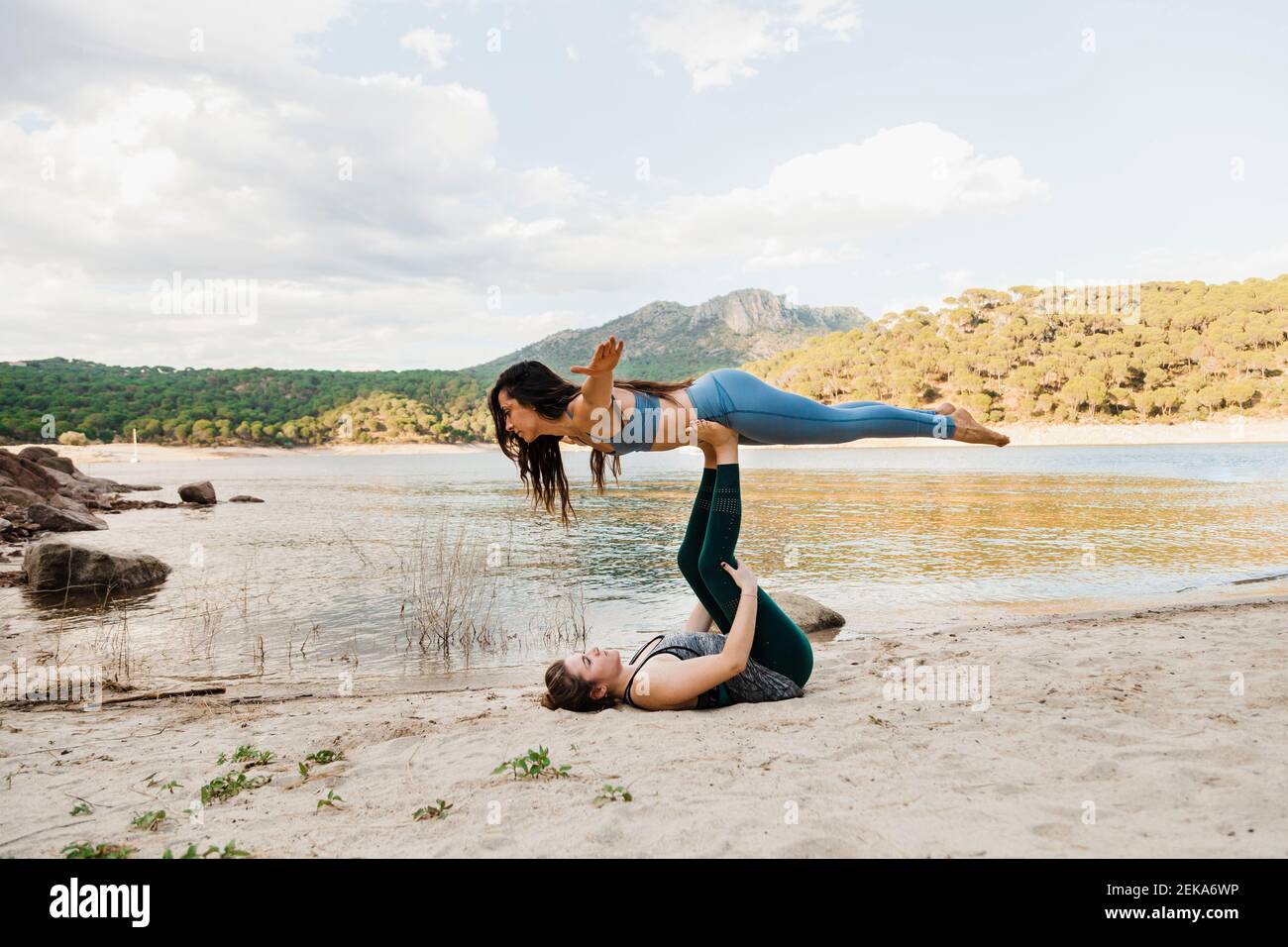 Young women doing acroyoga Stock Photo - Alamy