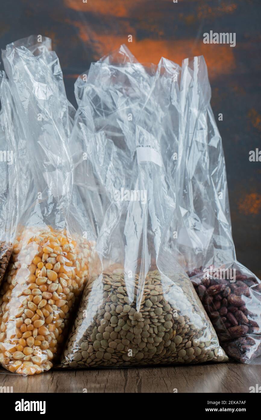 Different kinds of beans packed on a gray background Stock Photo - Alamy