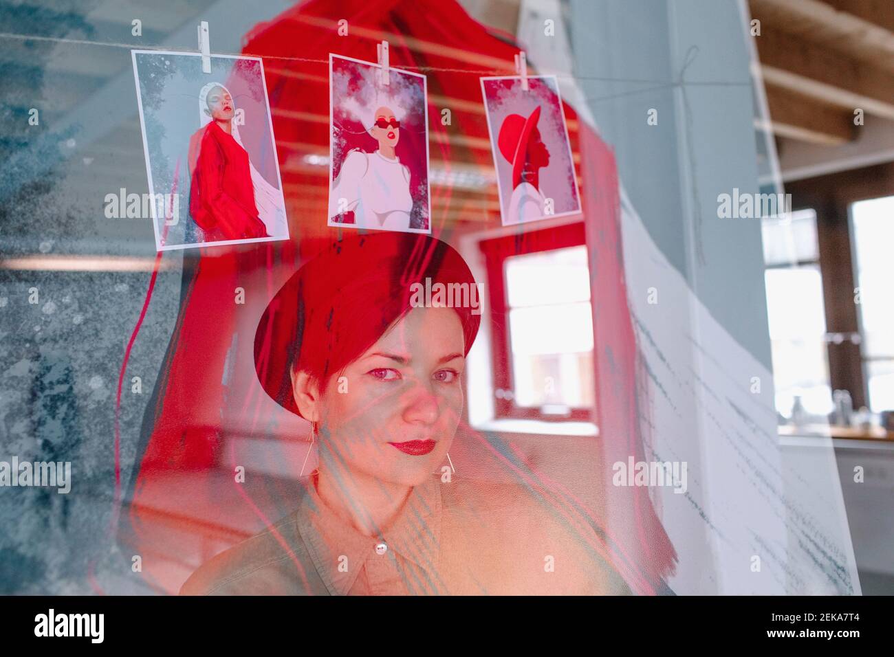 Woman staring while standing behind transparent curtain at studio Stock ...