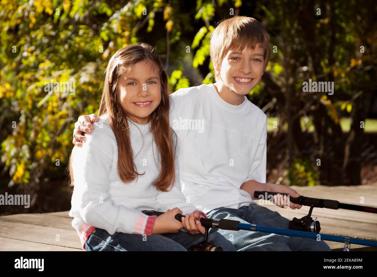 Girl fly fishing with her brother Stock Photo - Alamy