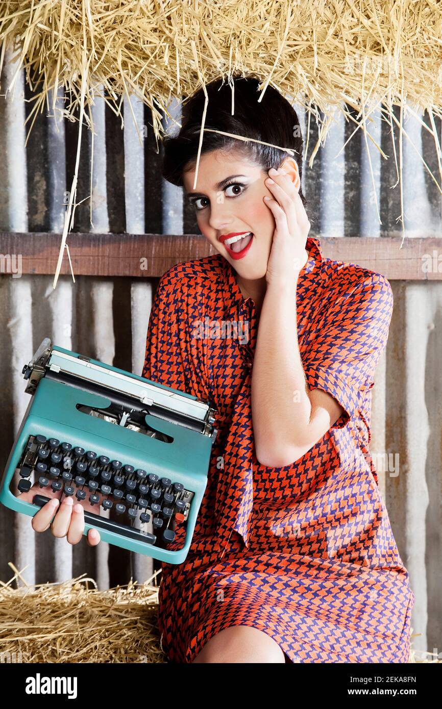 Woman holding a typewriter Stock Photo - Alamy