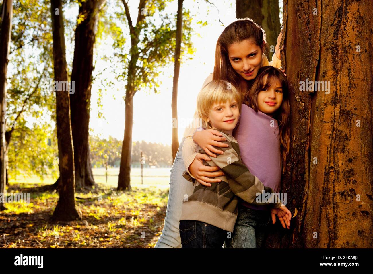 Family hugging each other in a garden Stock Photo - Alamy