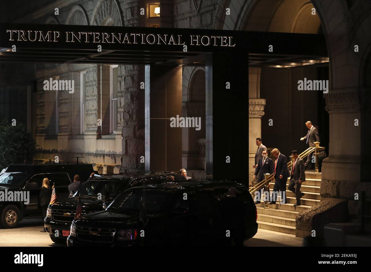 President Donald Trump walks out of the Trump International Hotel on ...