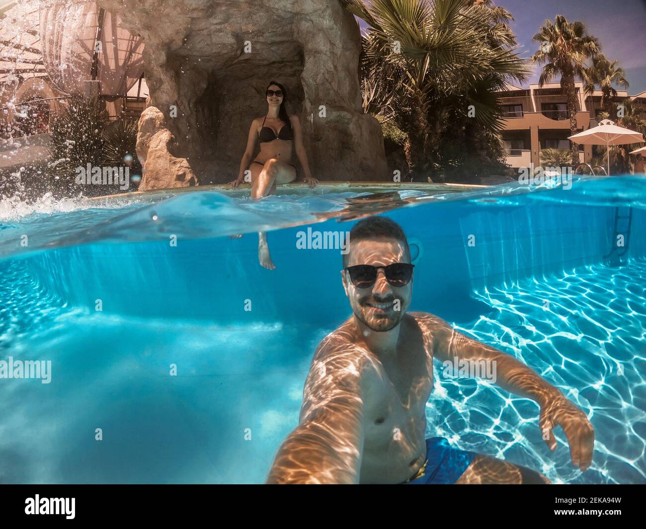 Beautiful couple summer selfie shot under above water surface at pool ...