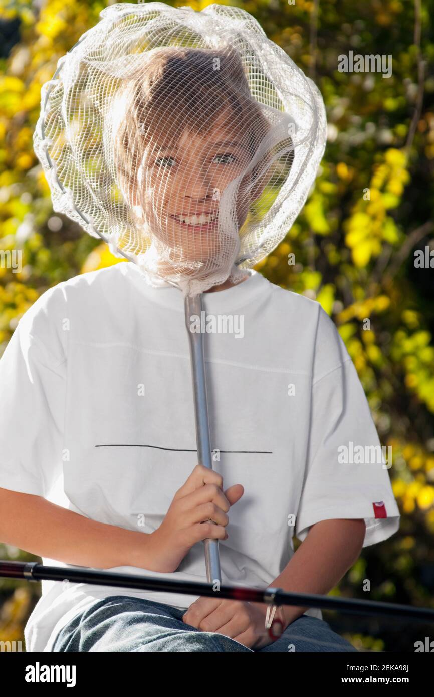 Portrait of a boy holding a fishing net Stock Photo - Alamy