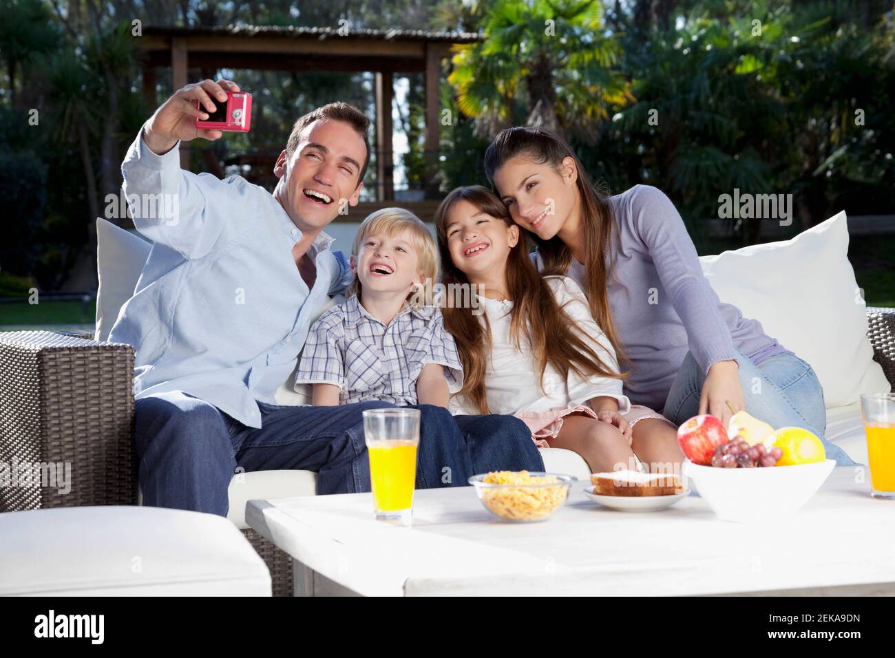 Man taking a picture of his family with a digital camera Stock Photo ...