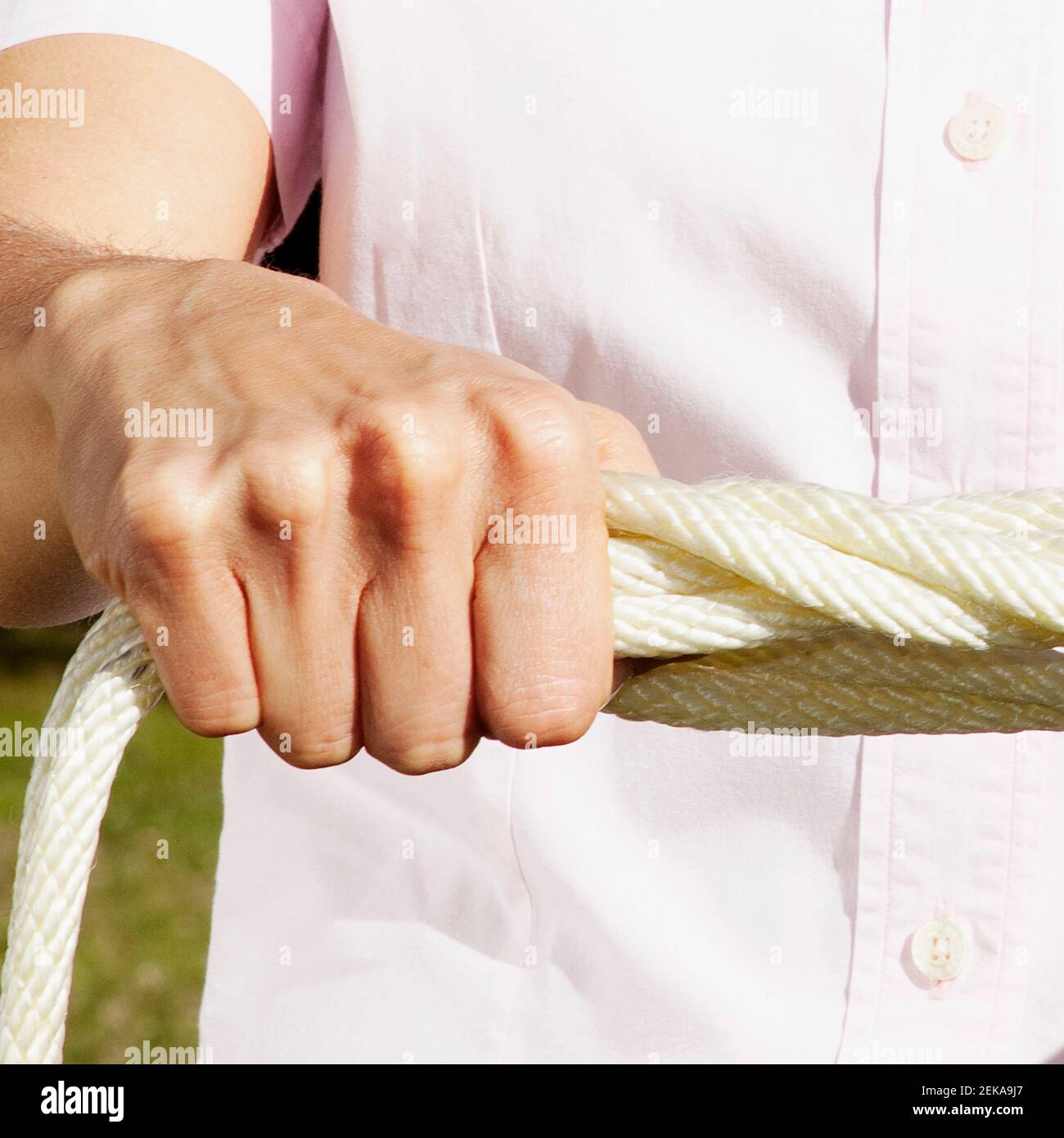 Mid section view of a businesswoman holding ropes Stock Photo - Alamy