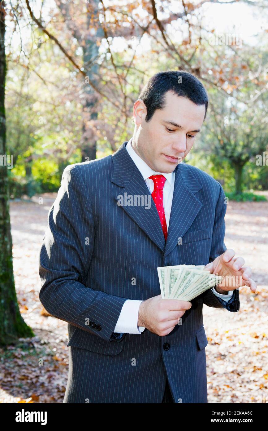 Businessman counting money Stock Photo - Alamy