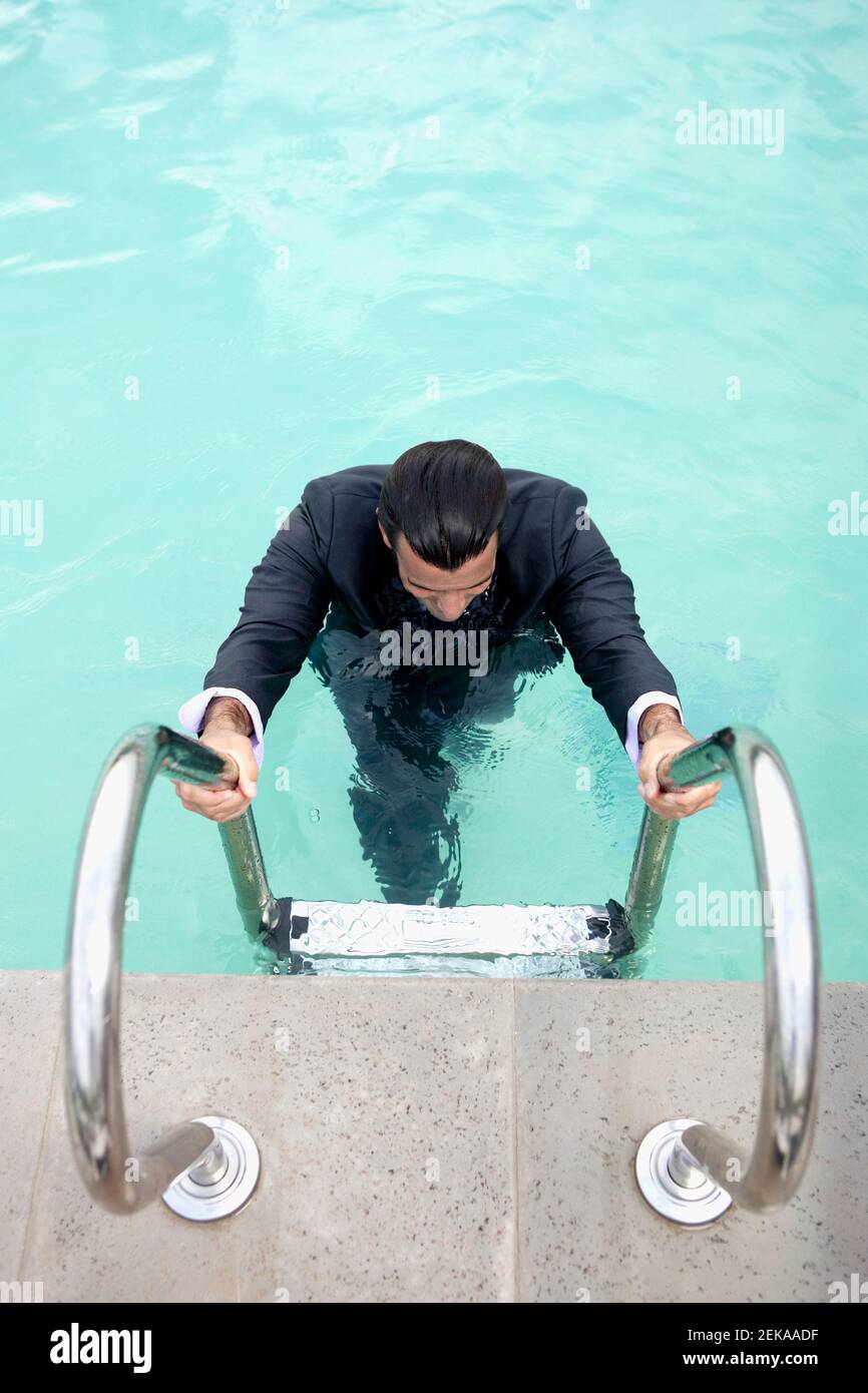 Wet businessman coming out from a swimming pool Stock Photo - Alamy