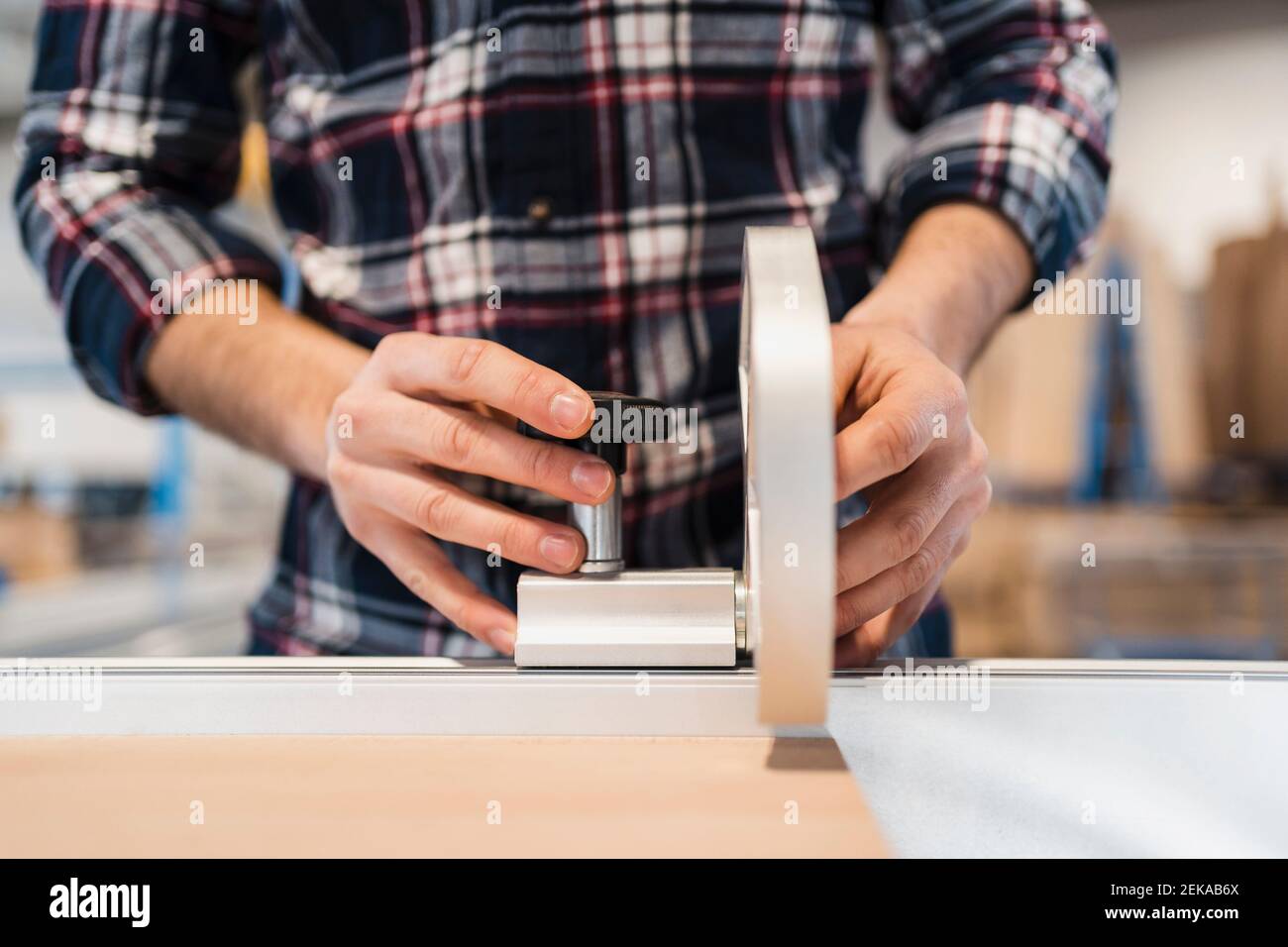 Manual worker working with hand tool while standing at industry Stock ...