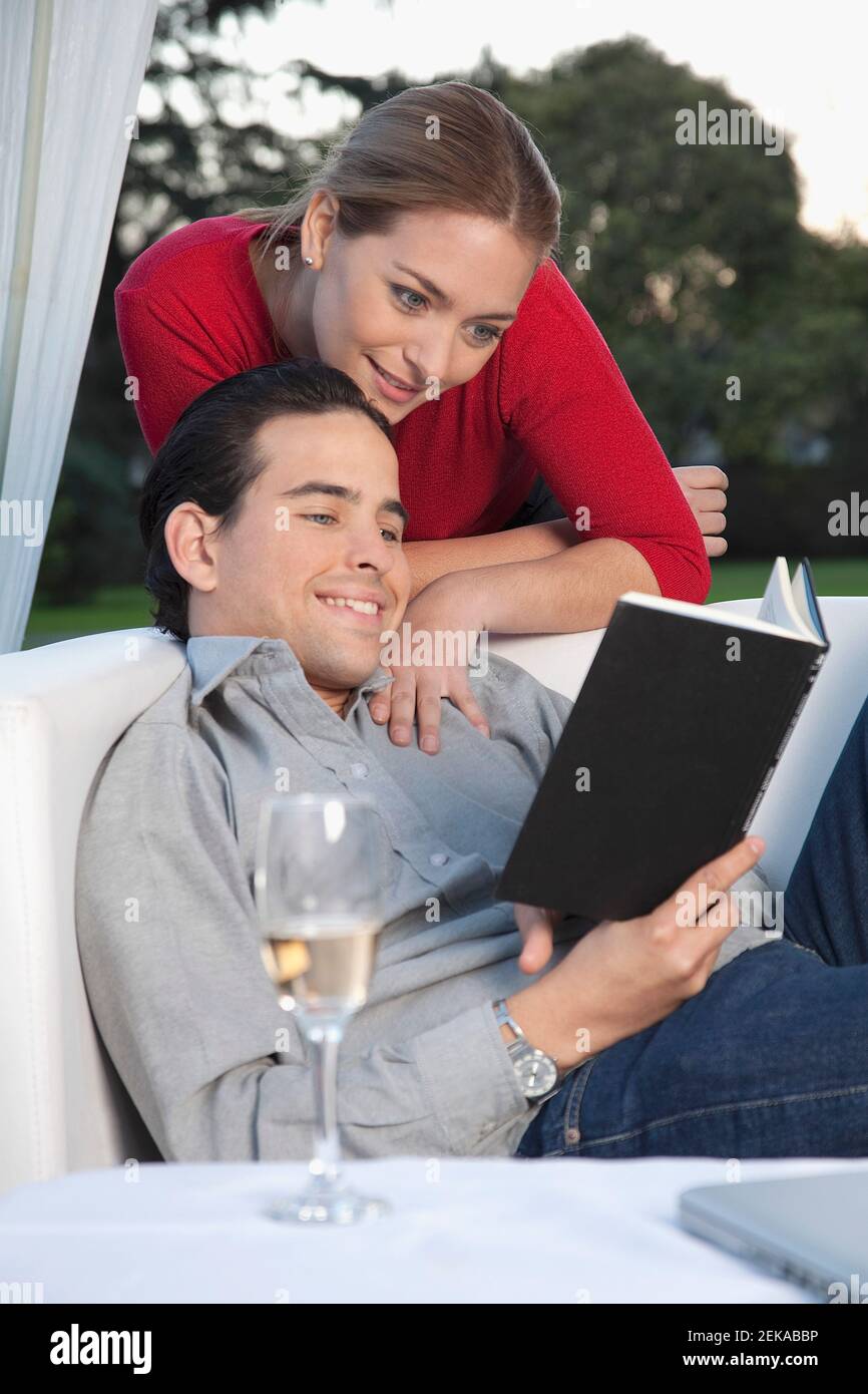 Couple reading a book Stock Photo - Alamy