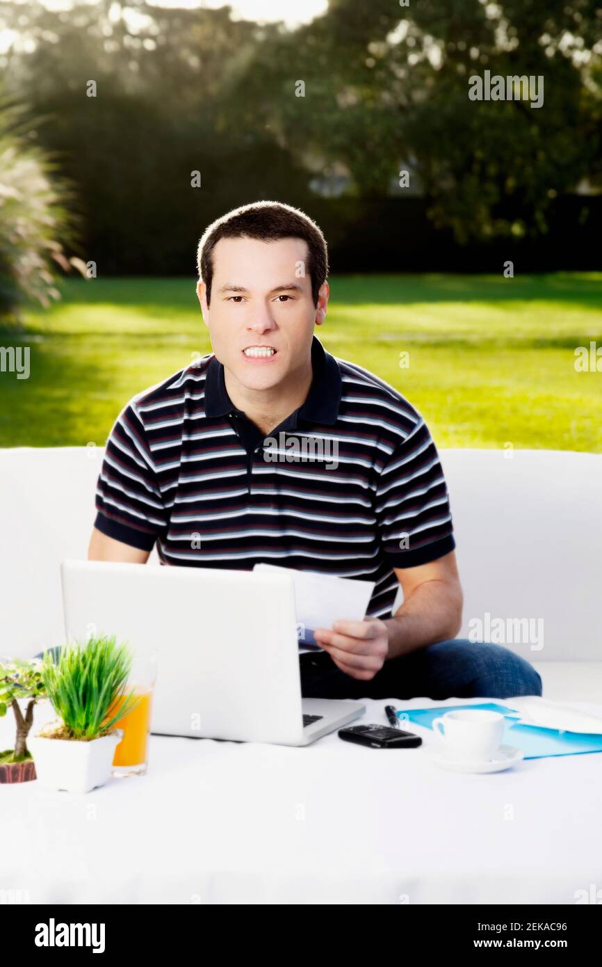 Portrait of a man clenching teeth Stock Photo - Alamy