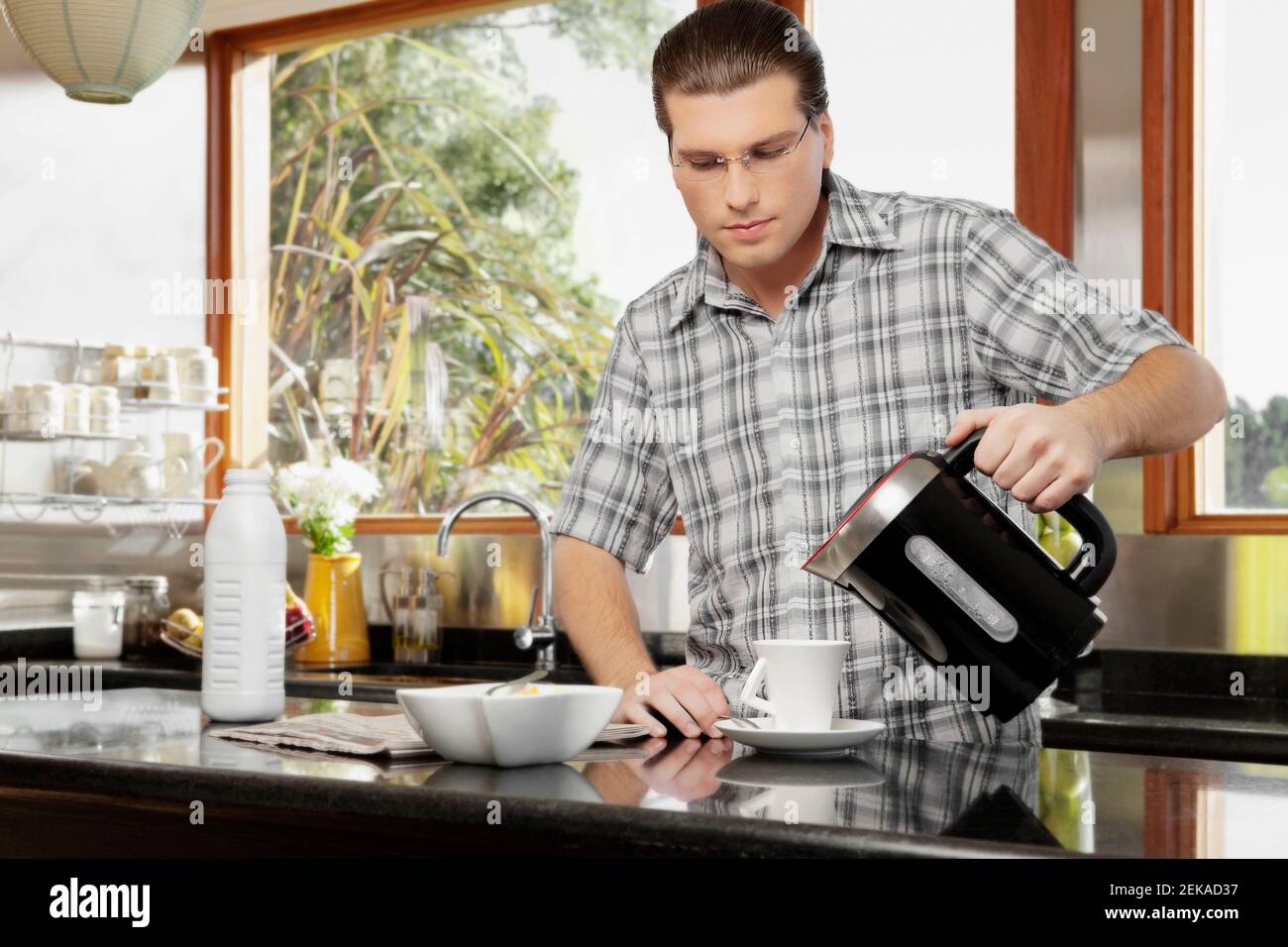 Man pouring coffee in the cup Stock Photo - Alamy