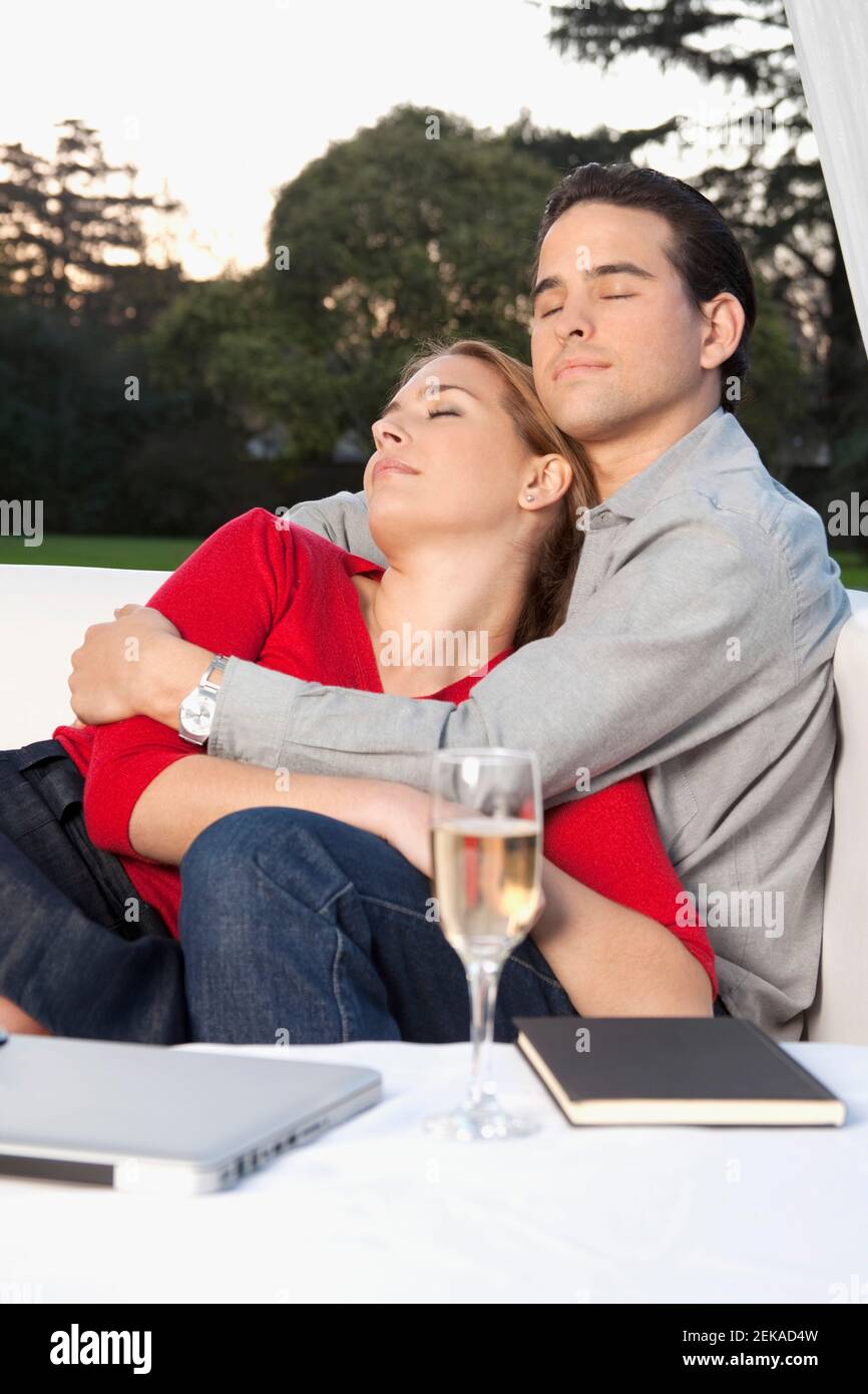 Woman napping on a couch with her husband Stock Photo - Alamy