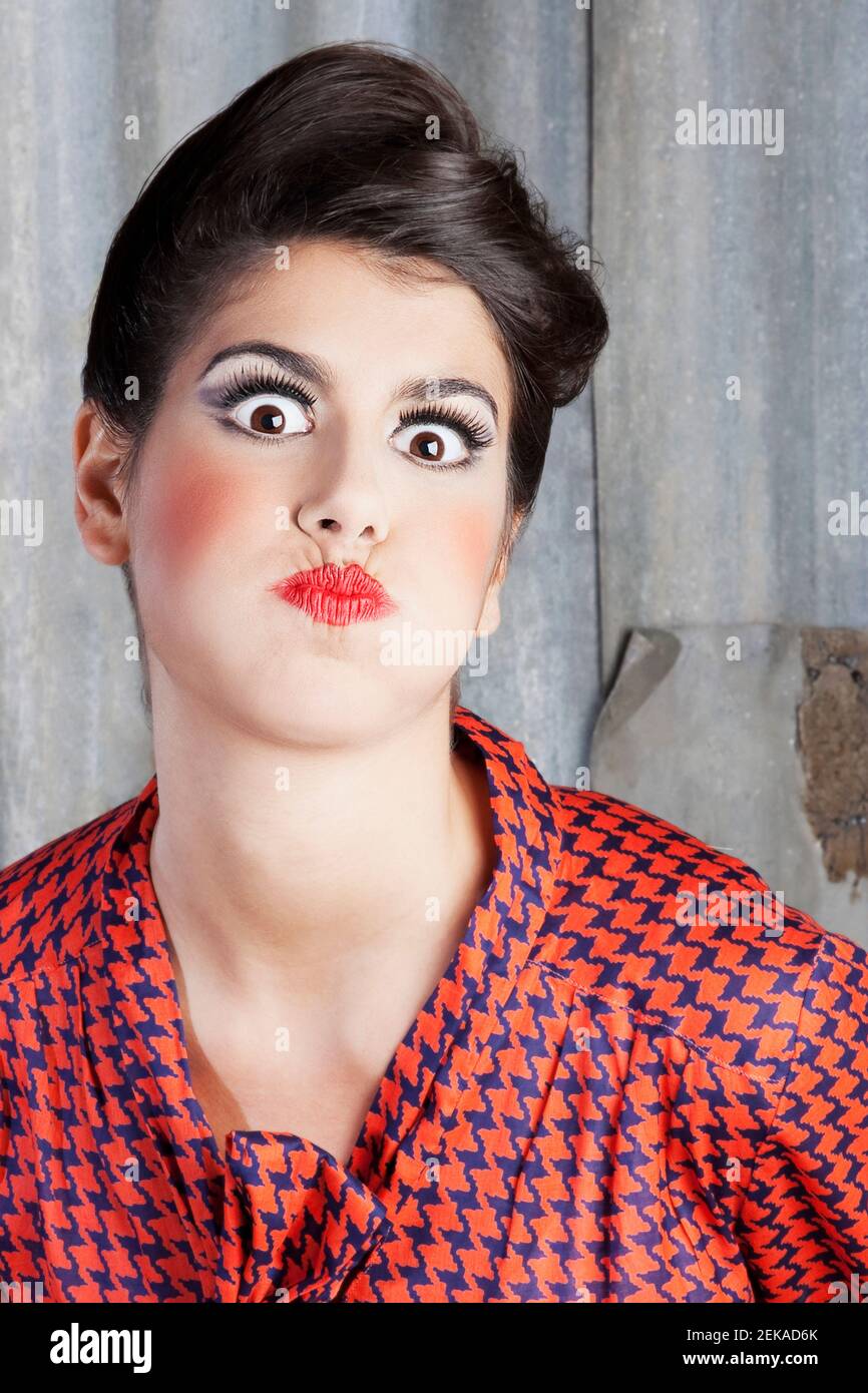 Portrait of a woman blowing cheeks Stock Photo - Alamy