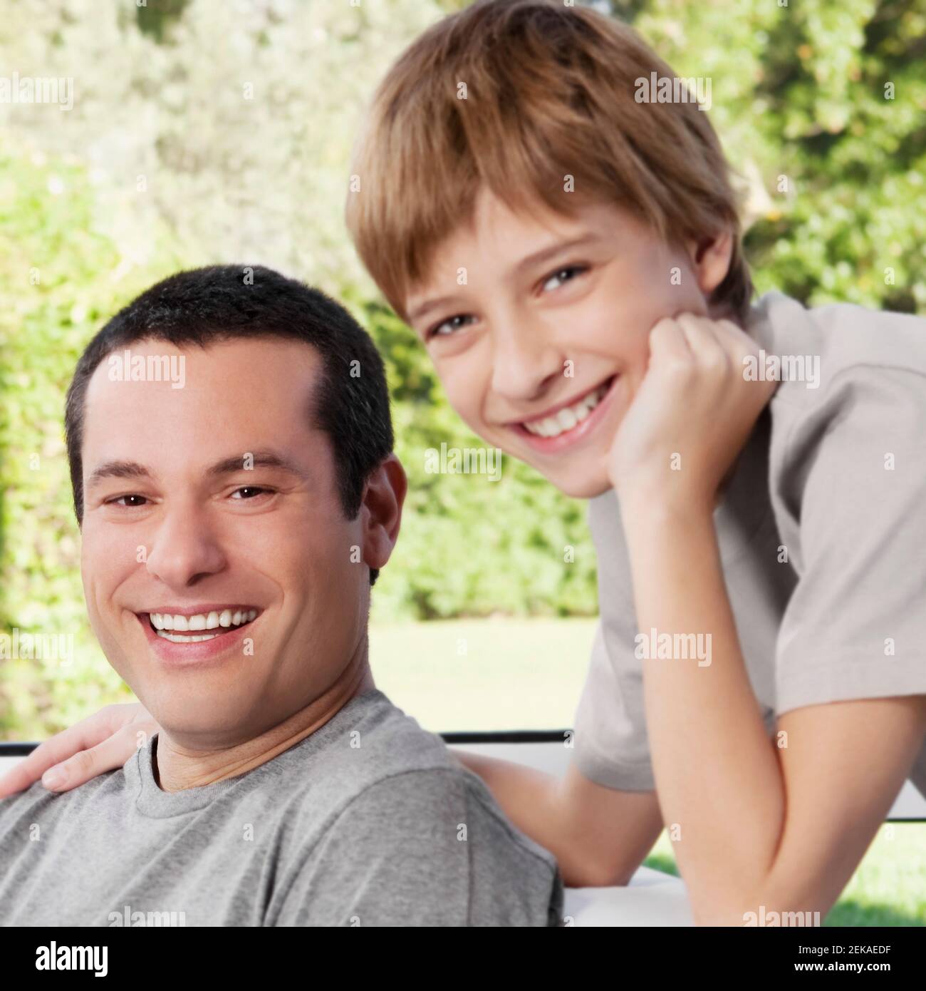 Portrait of a boy smiling with his father Stock Photo - Alamy