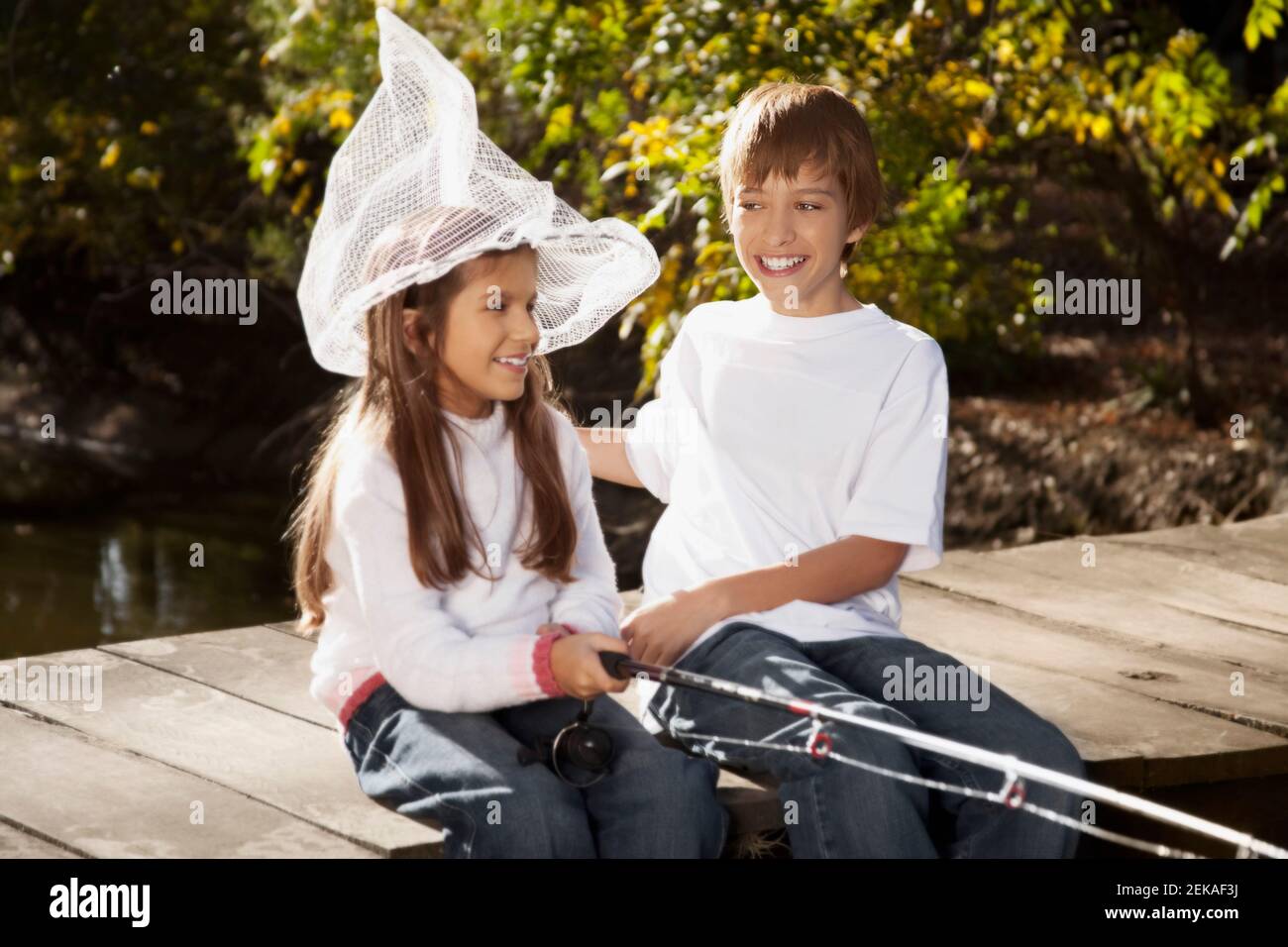 Girl fly fishing with her brother Stock Photo - Alamy