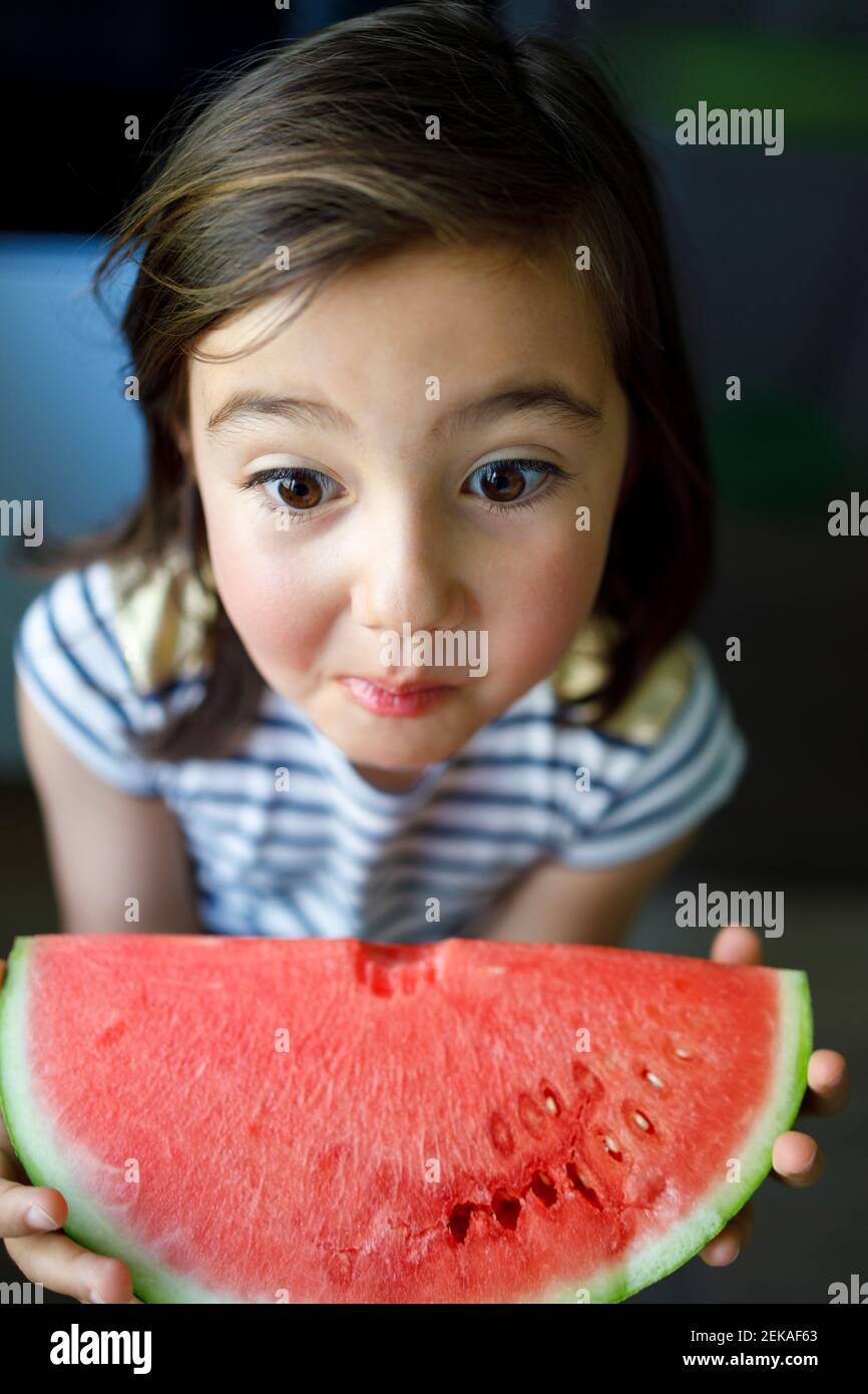 Smiling cute girl holding watermelon Stock Photo - Alamy