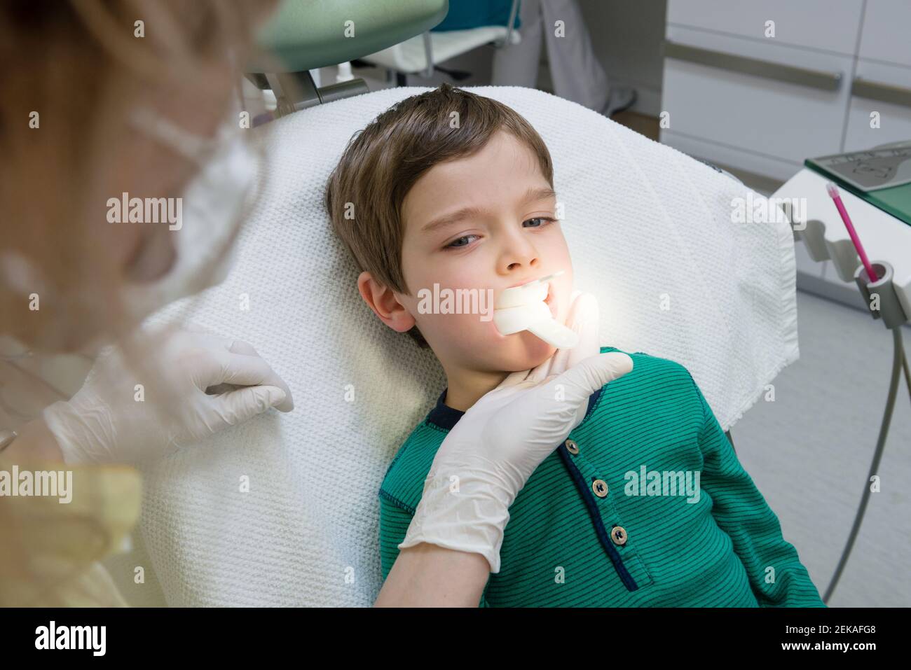 Dentist appointment - kid opening mouth wide during inspection of oral ...
