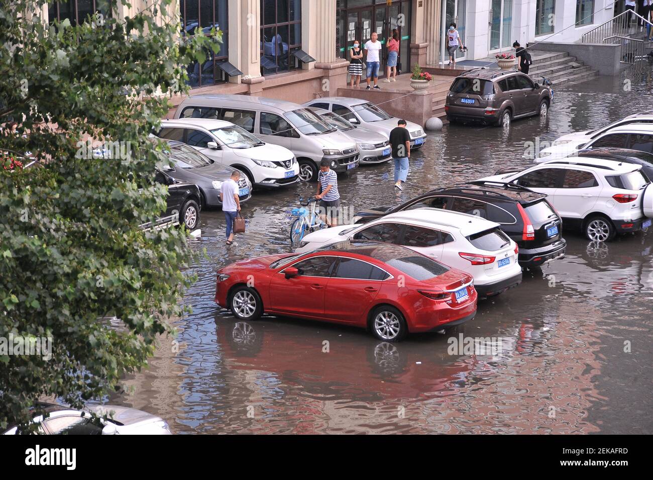 Cars are jamed in the water-logging caused by sudden heavy rain and ...