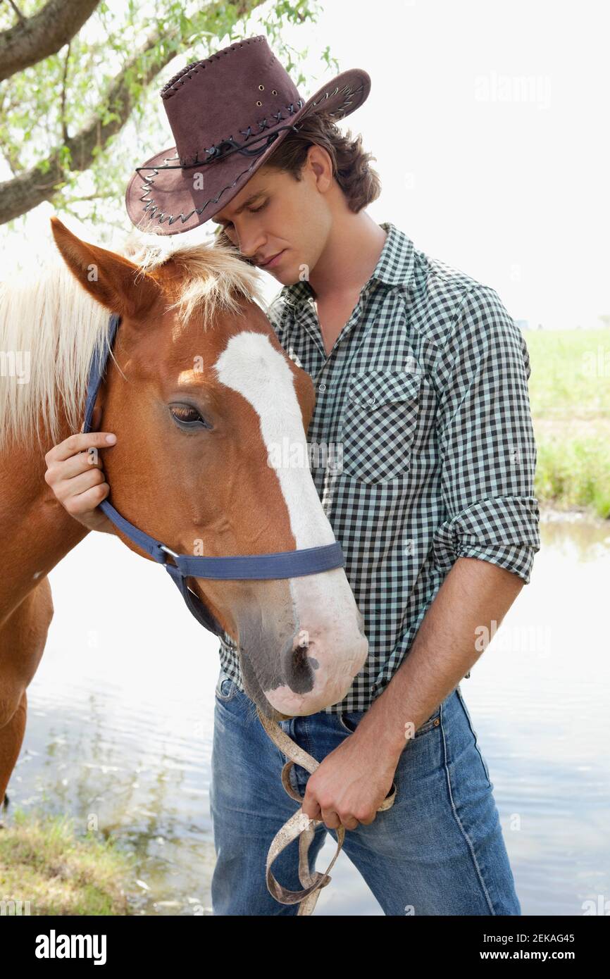 Man standing with a horse Stock Photo - Alamy