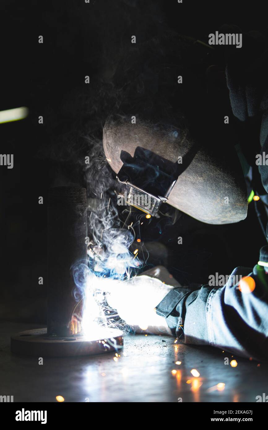 Male professional welder in welding helmet working at workshop Stock ...