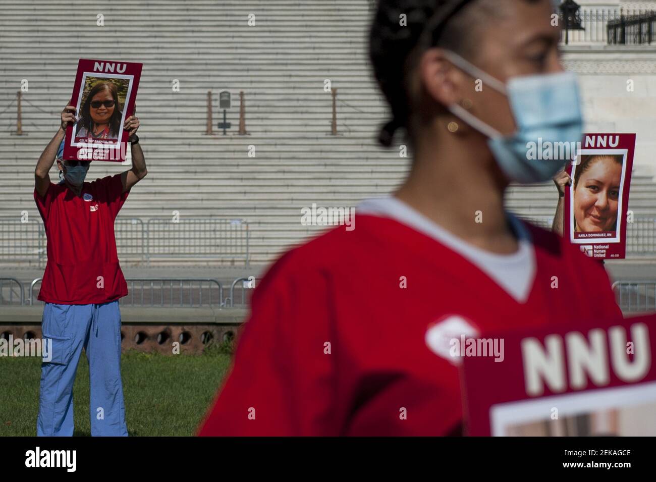 Members of National Nurses United hold a memorial to honor the more ...