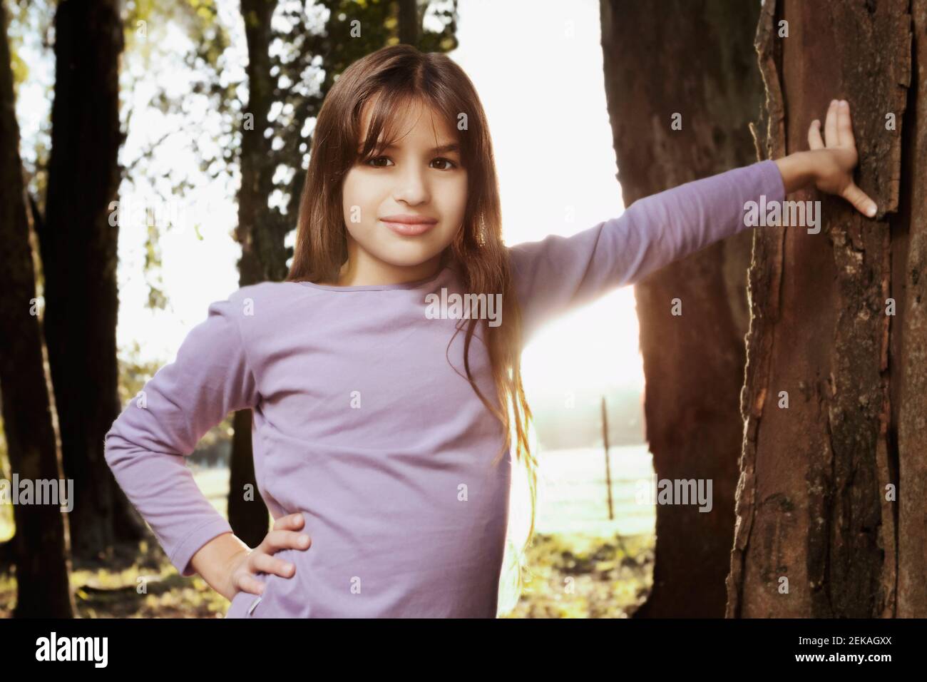 Kid leaning against tree hi-res stock photography and images - Alamy