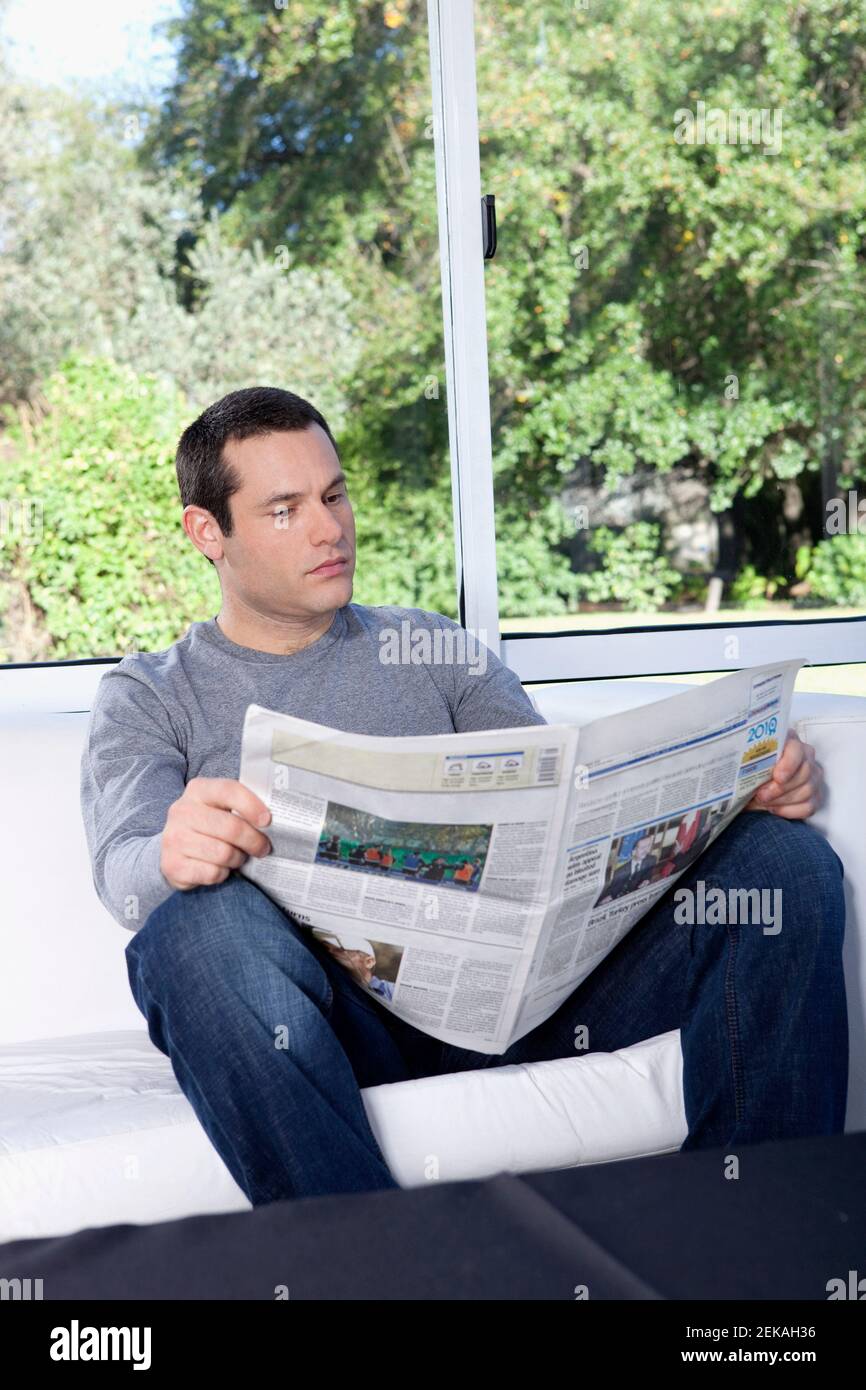Man reading a newspaper in the park Stock Photo - Alamy