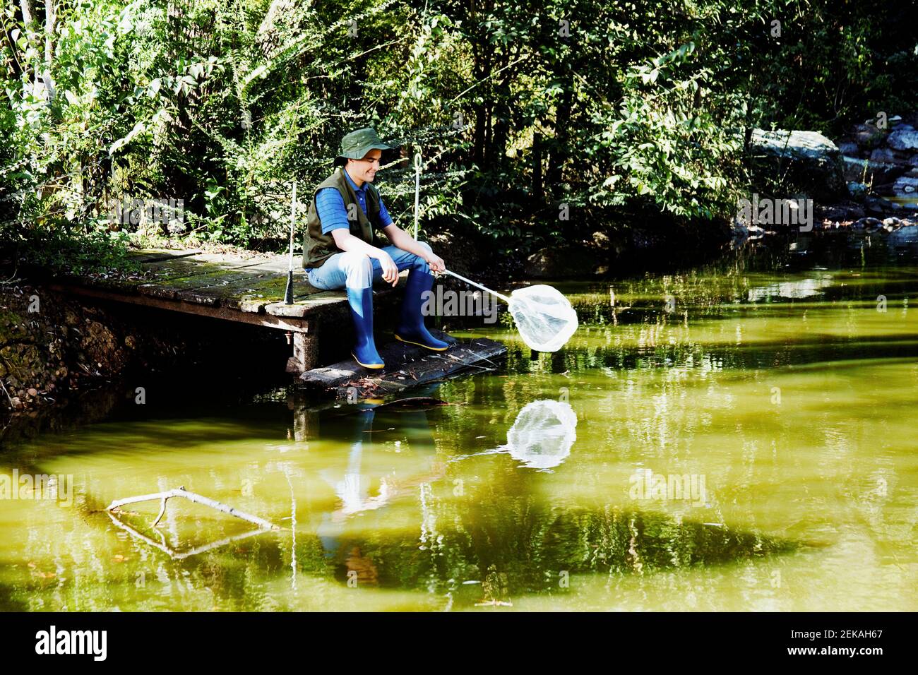 Man fishing in a river Stock Photo - Alamy
