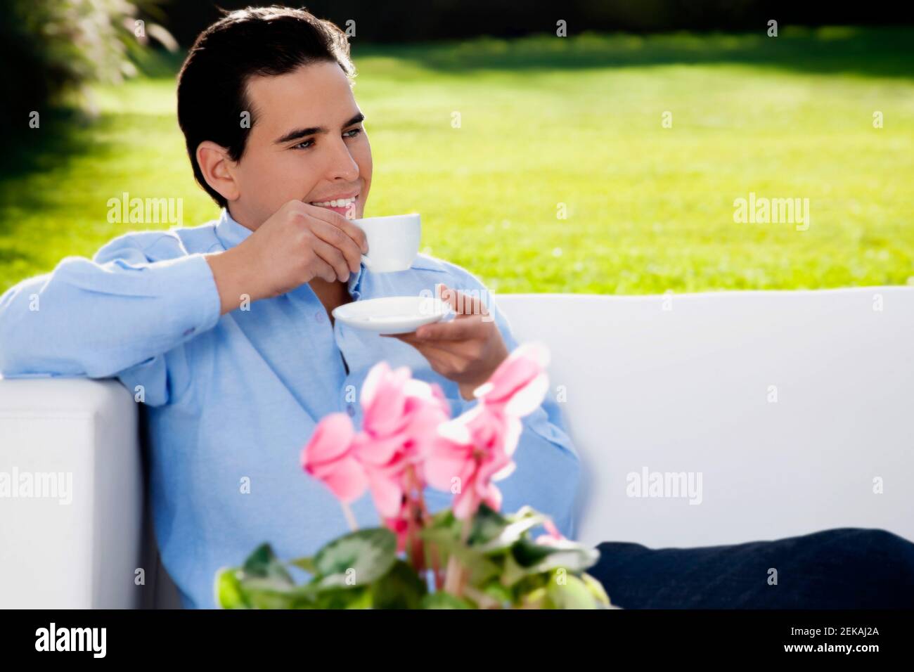Man drinking tea in a lawn Stock Photo - Alamy