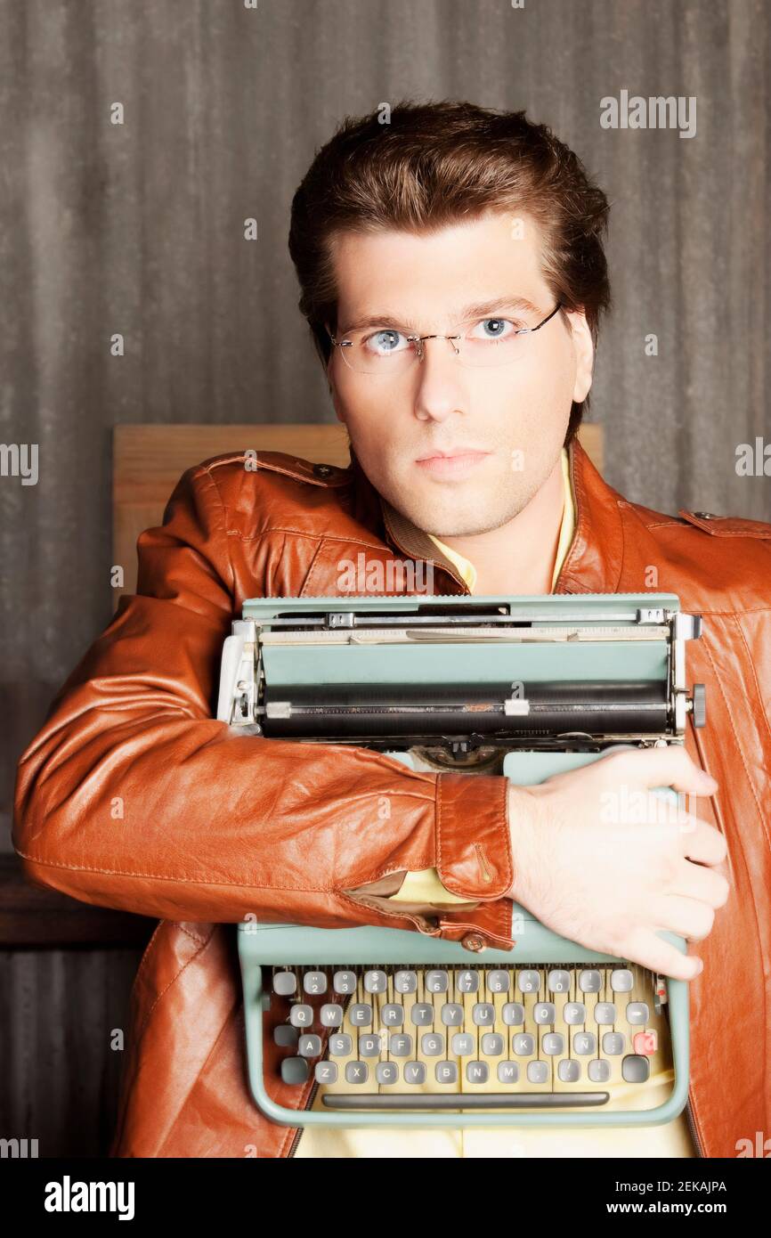 Man carrying a typewriter Stock Photo - Alamy