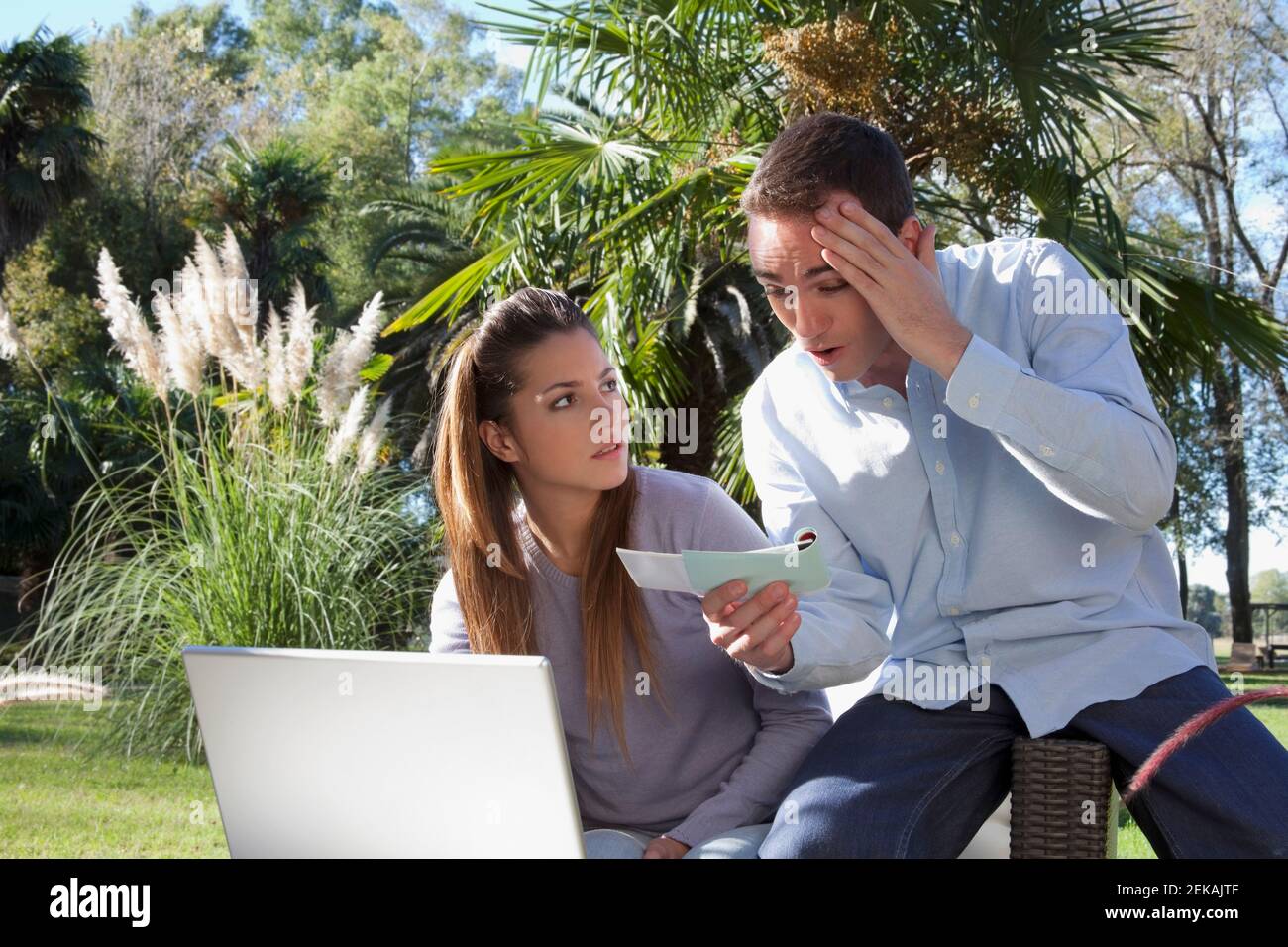 Man looking surprised while checking his bank account Stock Photo - Alamy