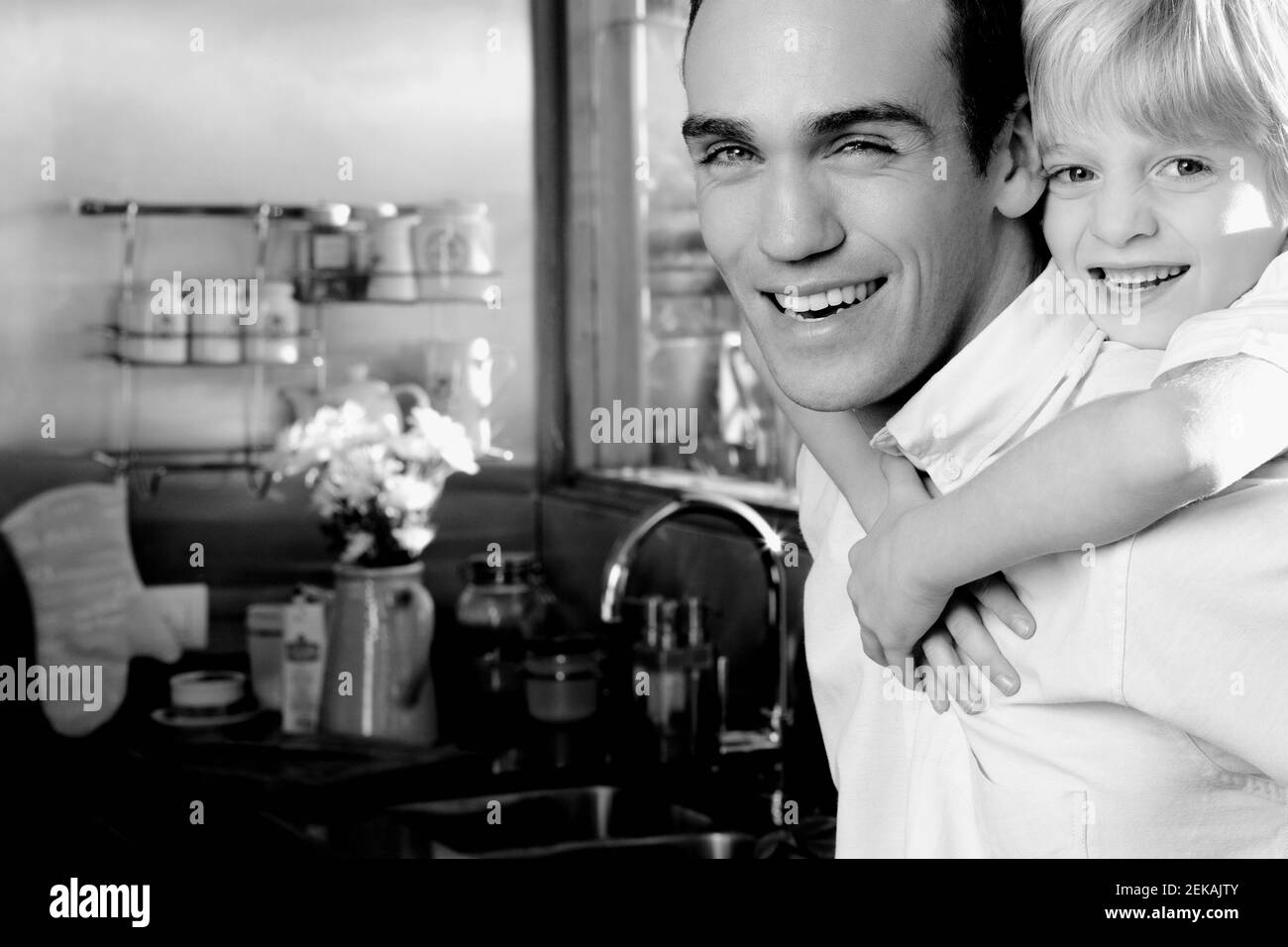 Portrait of a man with his son in the kitchen Stock Photo - Alamy