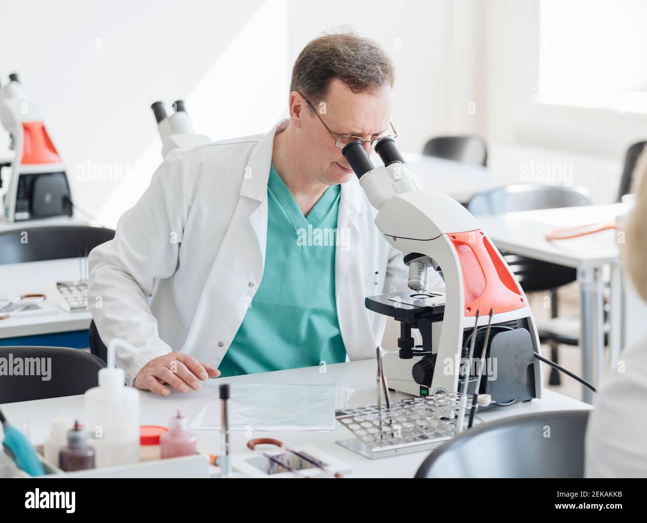 Senior researcher working with microscope in lab Stock Photo - Alamy