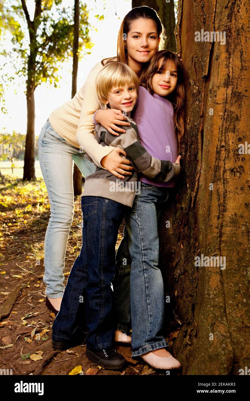 Family hugging each other in a garden Stock Photo - Alamy