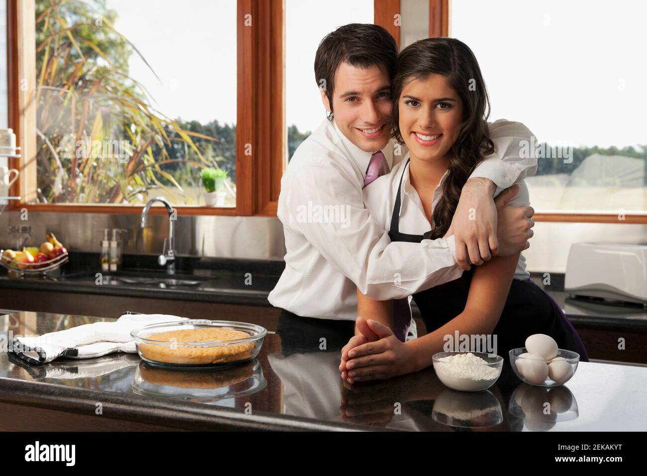 Couple romancing in the kitchen Stock Photo - Alamy
