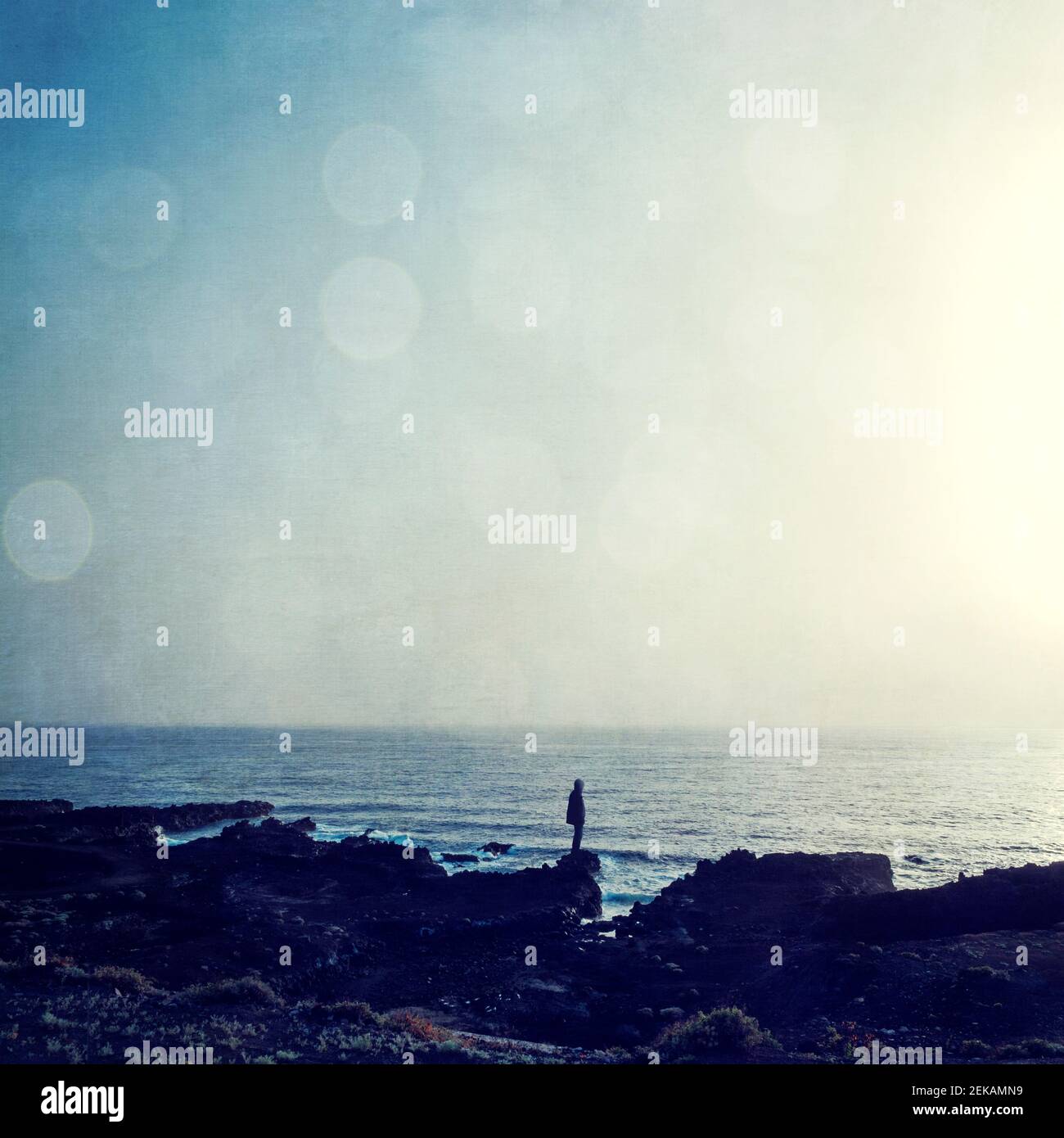 Man standing rock sunset looking view hi-res stock photography and ...