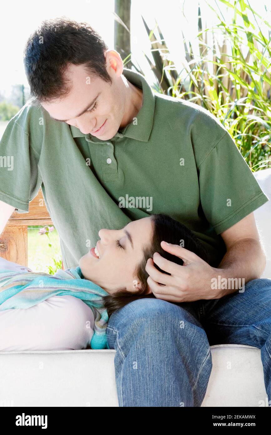 Woman resting on the lap of a man Stock Photo - Alamy